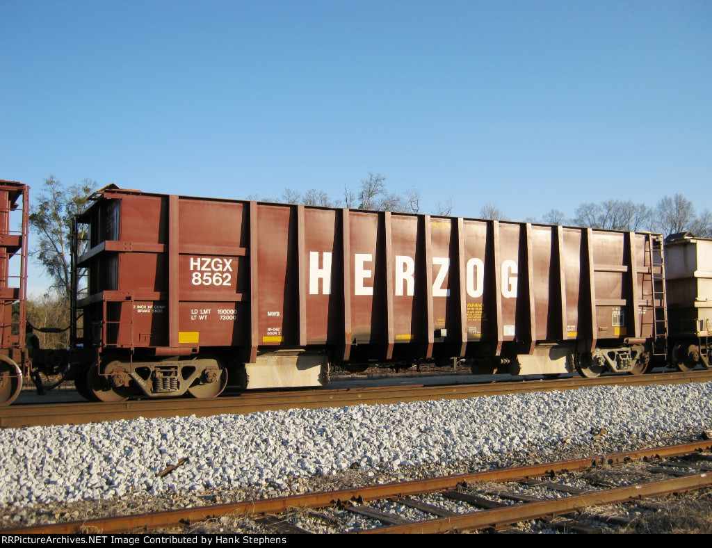 Portrait shot of Herzog Ballast train car in siding at West Point, GA